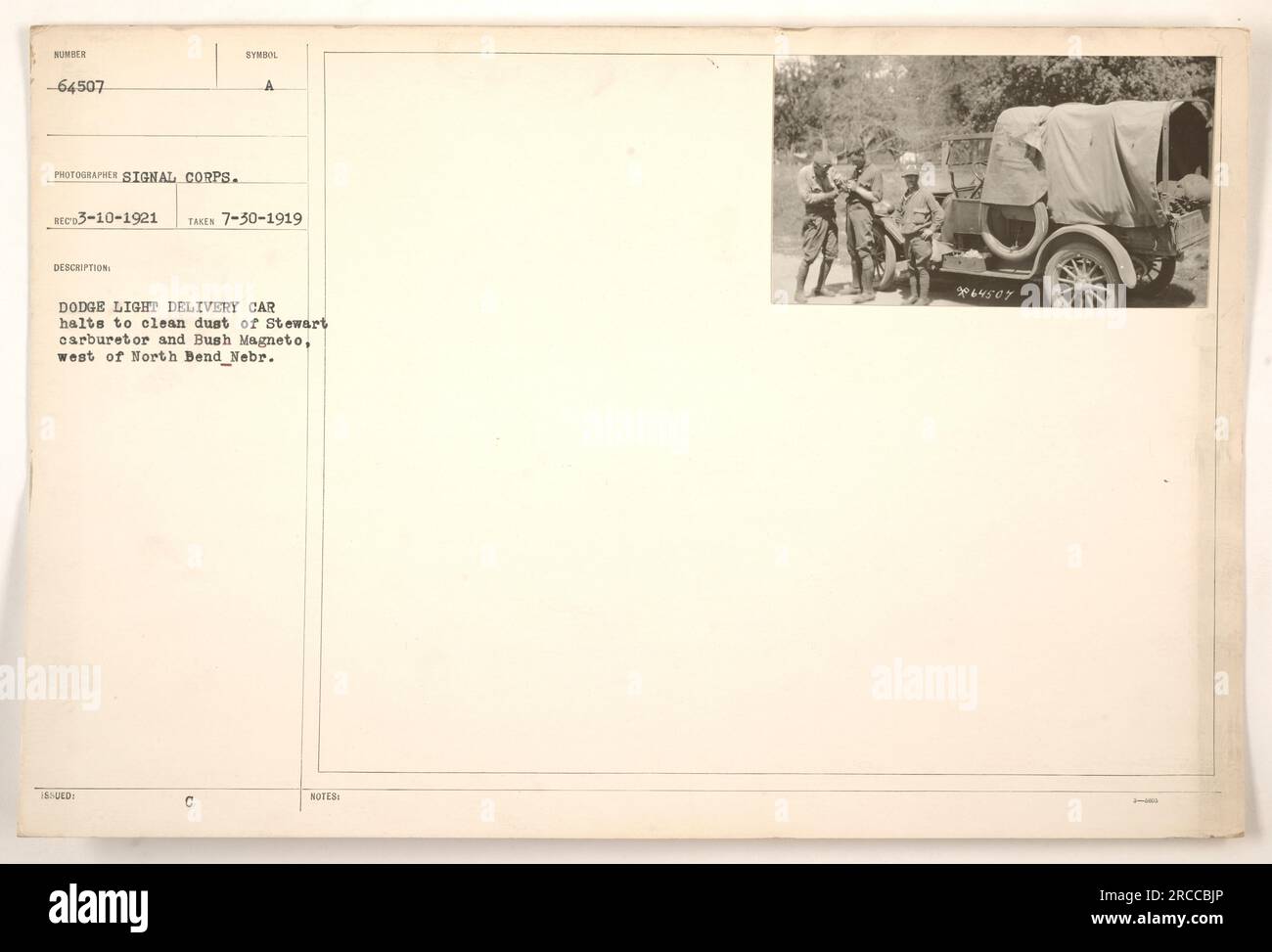 A Dodge light delivery car is shown halting to clean dust off of the ...