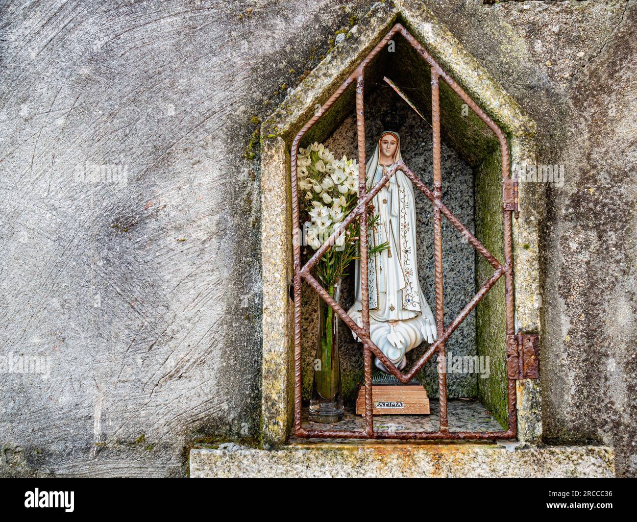 A traditional statue of a Virgin is placed on a wall. The Coastal Route ...