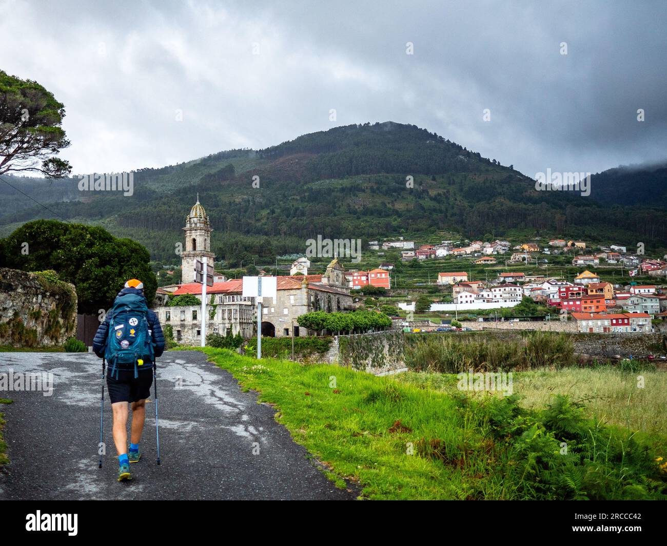 A pilgrim is seen getting closer to an old monastery. The Coastal Route ...