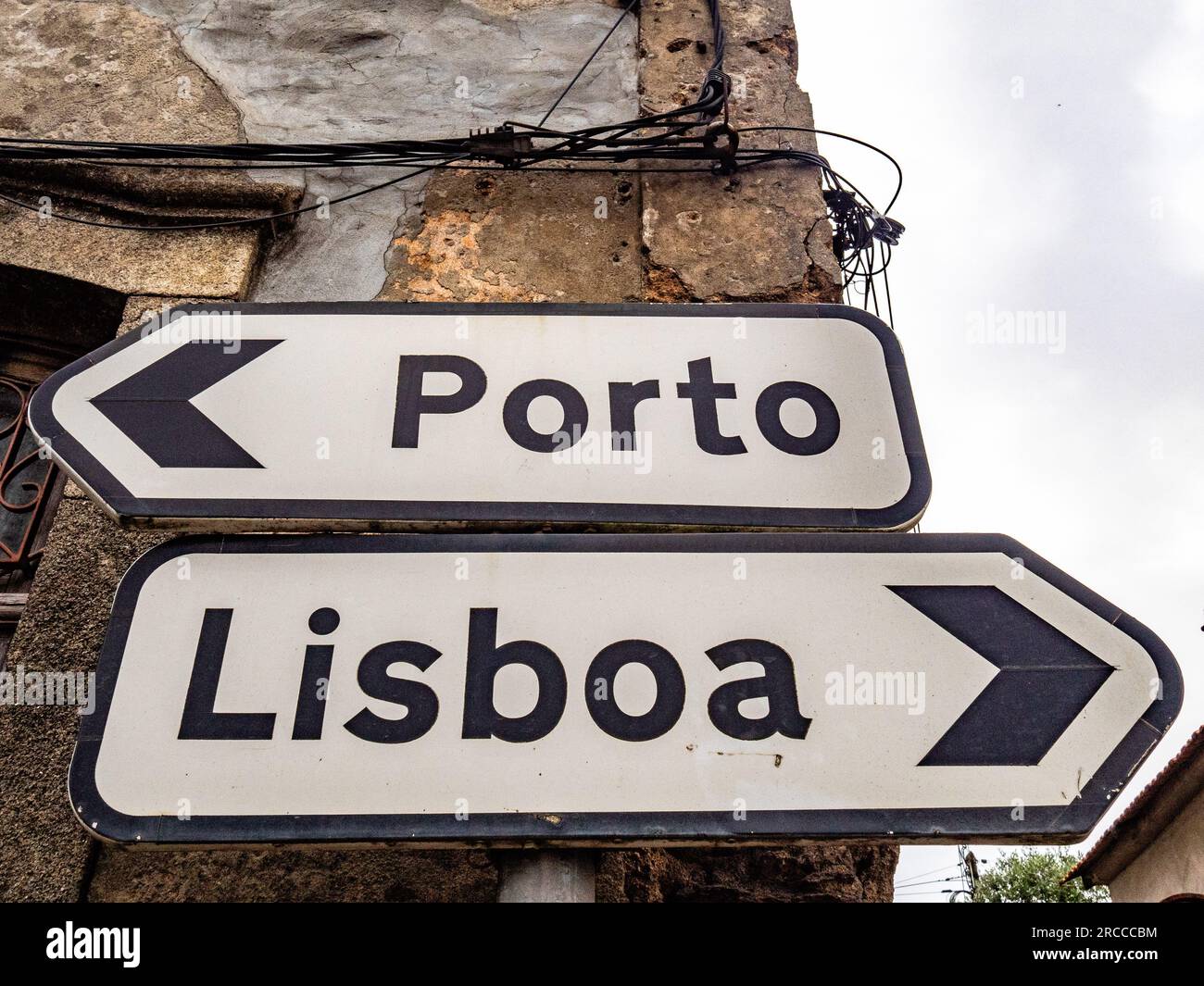 A view of two signs pointing to Lisbon and Porto. The Coastal Route of ...