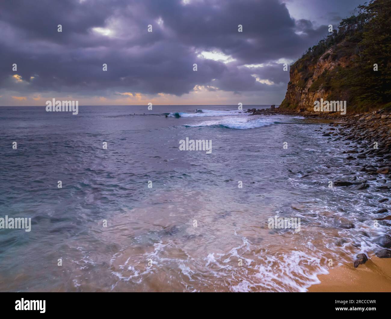 Aerial sunrise seascape with rain clouds and small waves at Macmasters ...