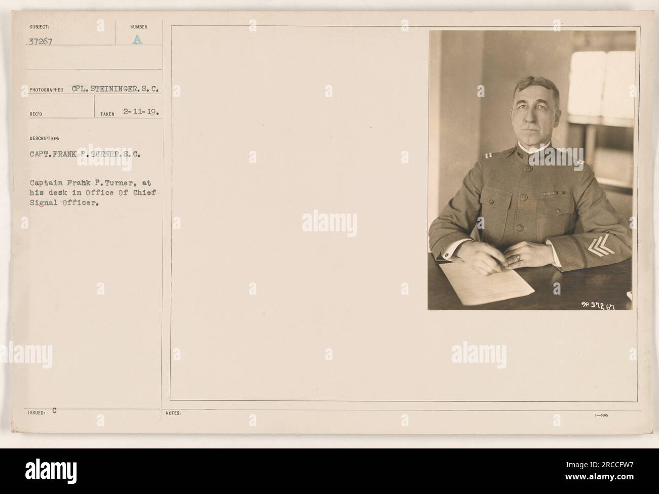 Captain Frank P. Turner, a Chief Signal Officer, is seen seated at his ...