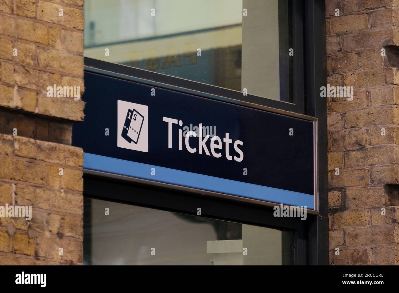 London, UK. A sign indicating the location of the ticket office at King ...