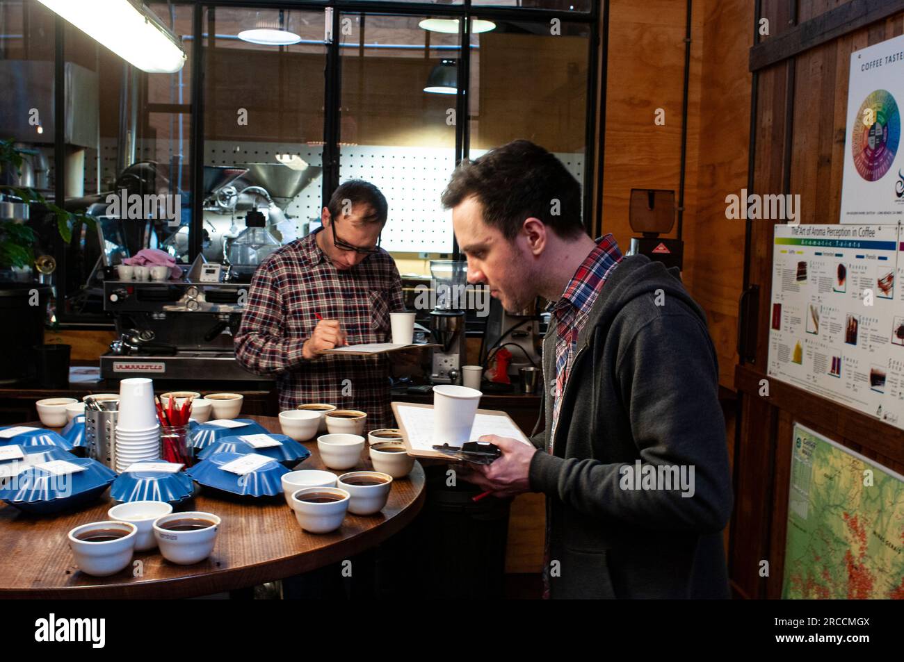 Specialist coffee tasters sampling and selecting coffee at Seven Seeds ...