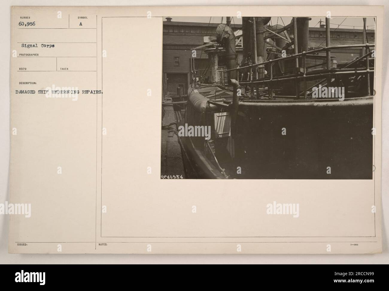 A damaged ship undergoing repairs at an unknown location during World ...