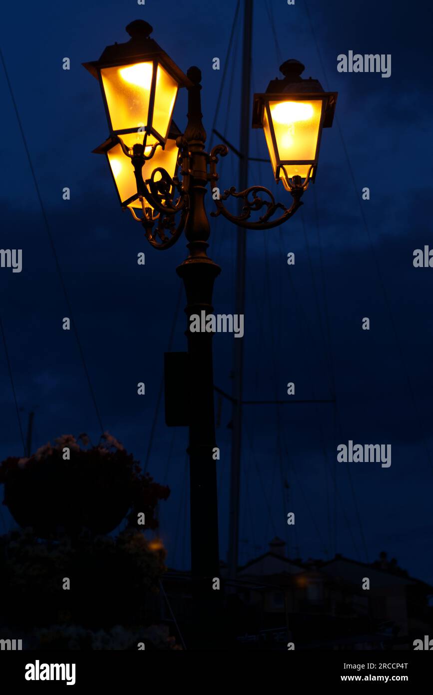 Vintage street lamp light at night - vertical Stock Photo - Alamy