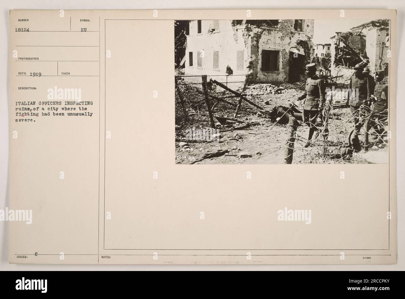 Italian officers inspecting the ruins of a city severely affected by ...