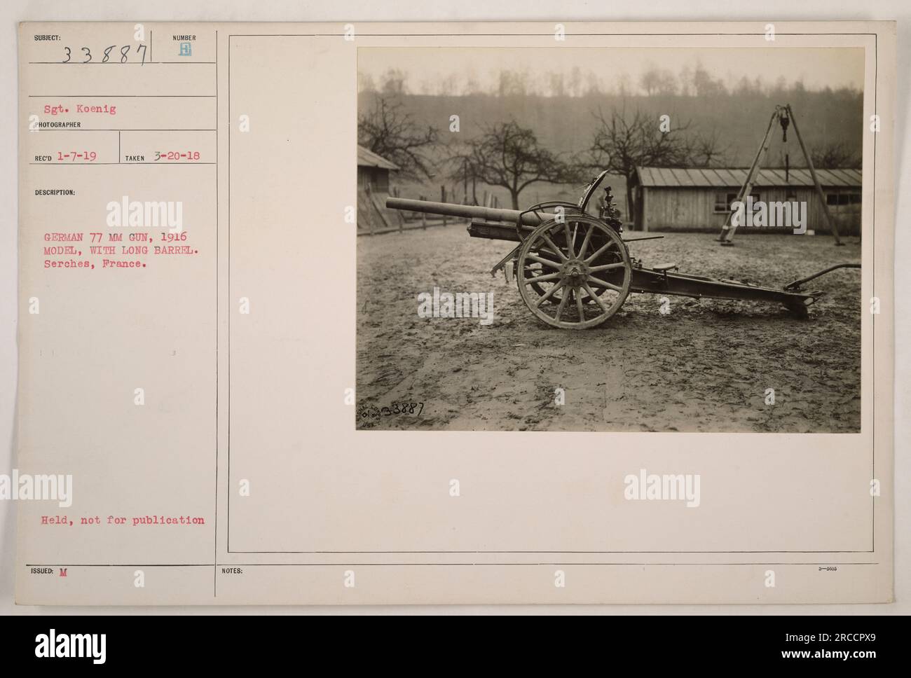 Sergeant Koenig holds a German 77 mm gun, model from 1916, featuring a ...