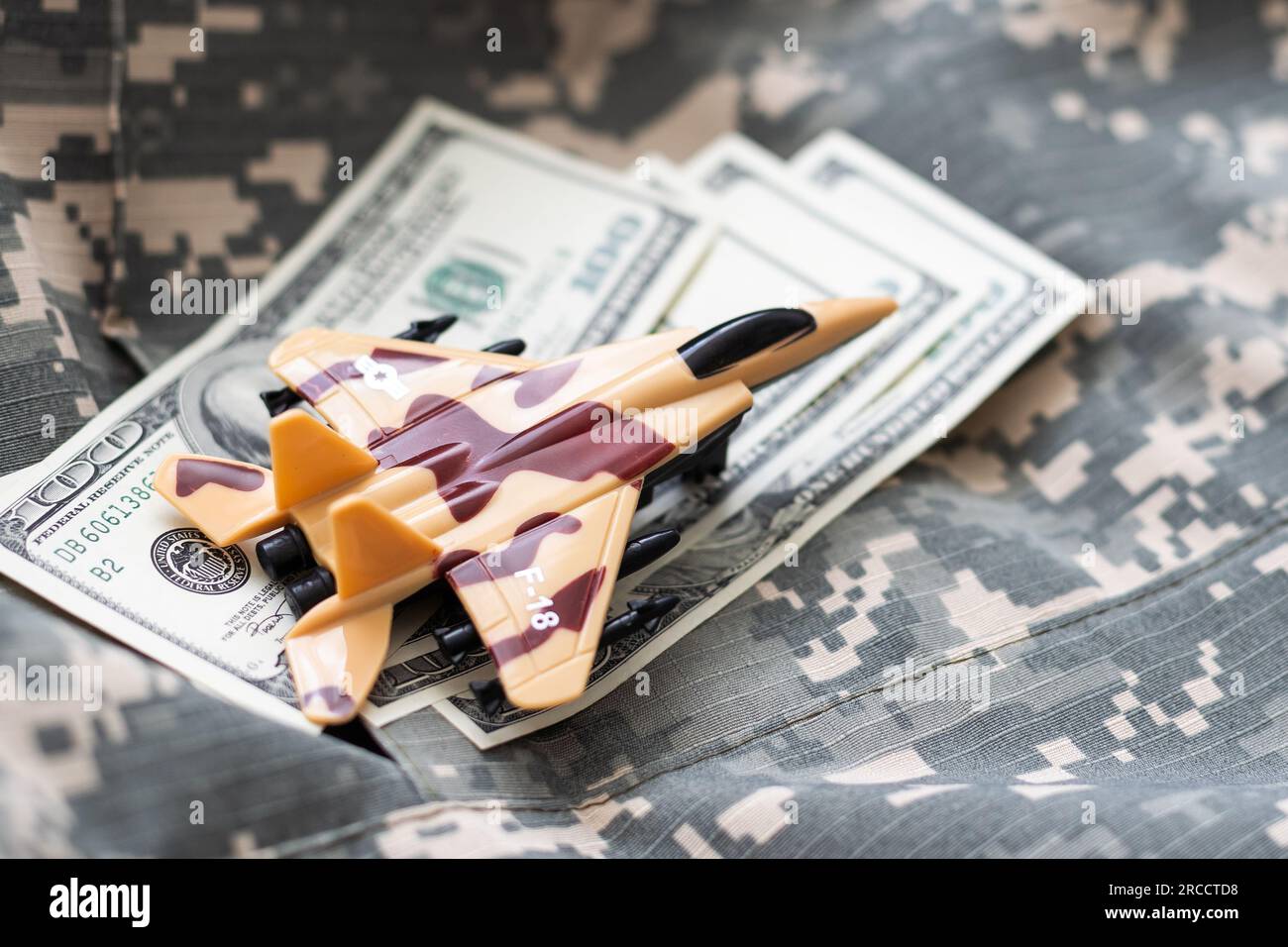 weapons on stacks of coins as a concept of the cost of military ...