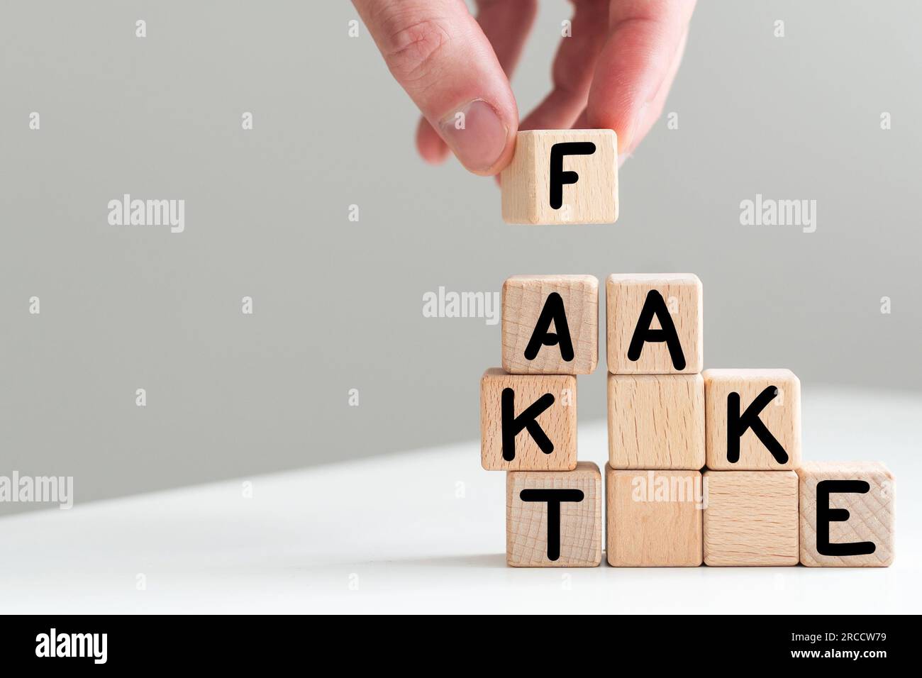 Hand putting wooden cubes for change wording from fake to fact Stock ...