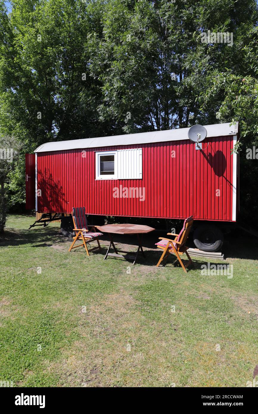 a red trailer with chairs and a table Stock Photo - Alamy