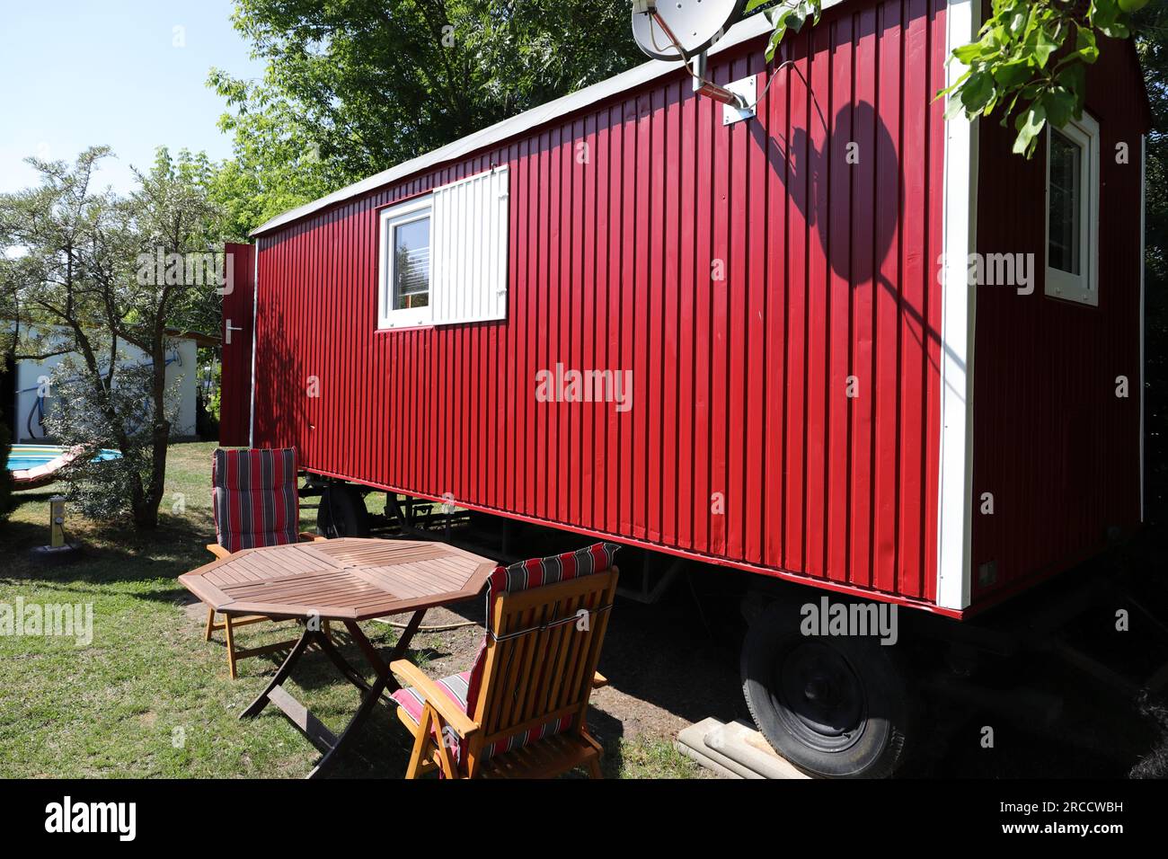 a red trailer with chairs and a table Stock Photo - Alamy