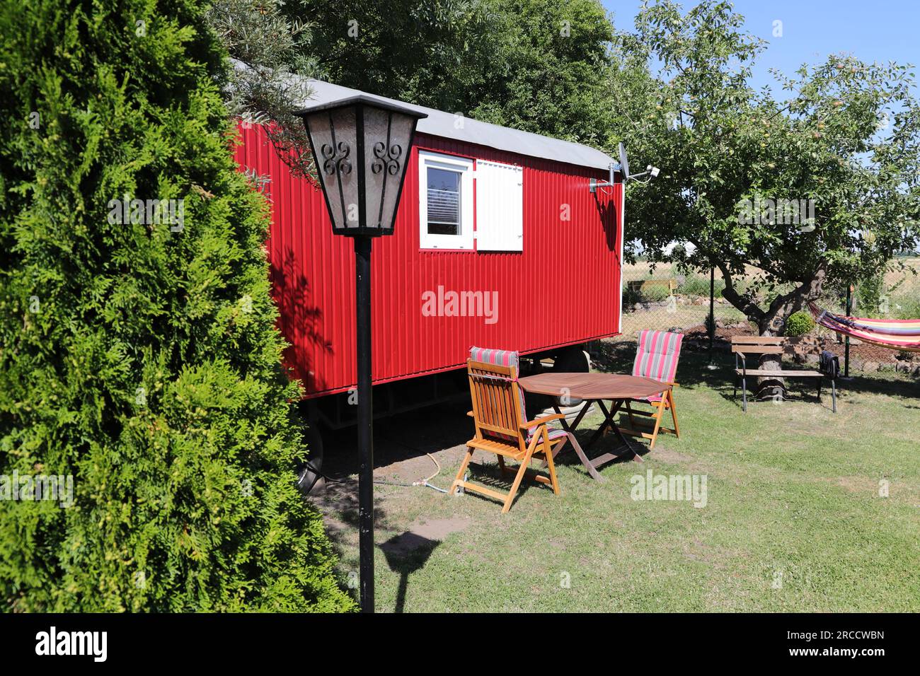 a red trailer with chairs and a table Stock Photo - Alamy