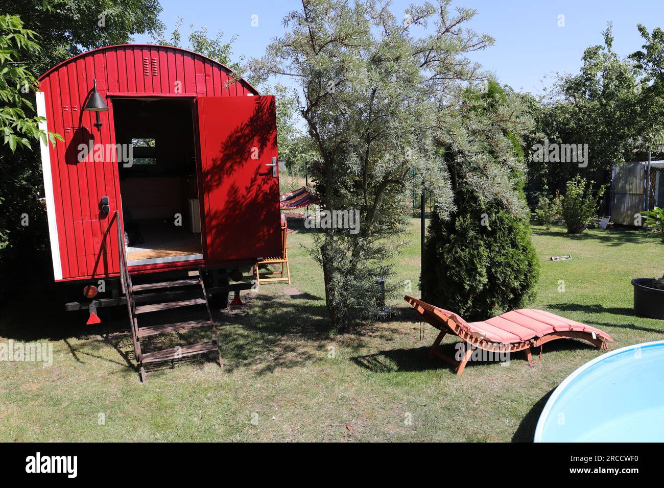 a red trailer with a lounger by the pool Stock Photo - Alamy