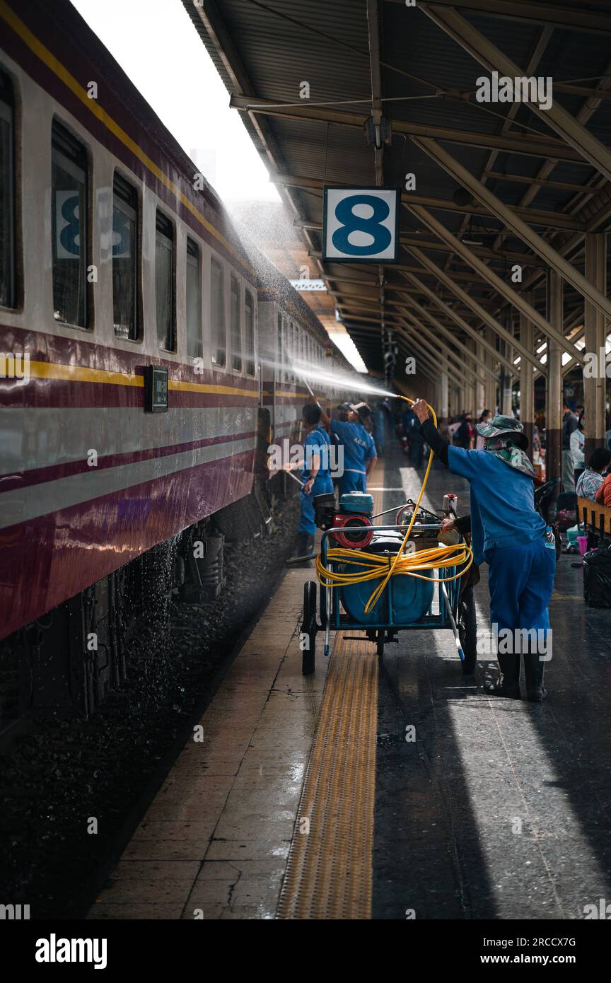 Workers cleaning the train splashing water Stock Photo - Alamy