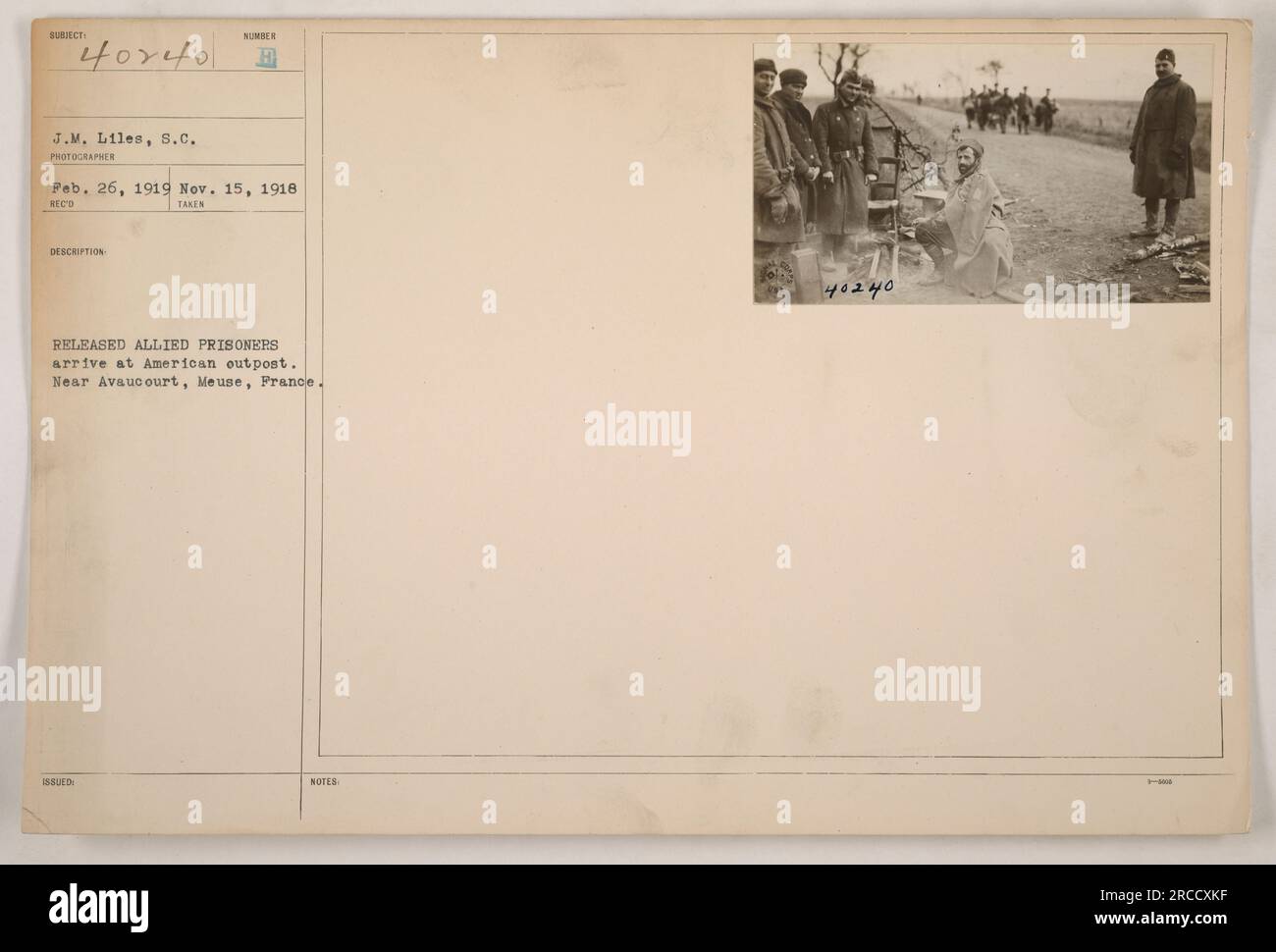 American soldiers overseeing the arrival of Allied prisoners at an ...