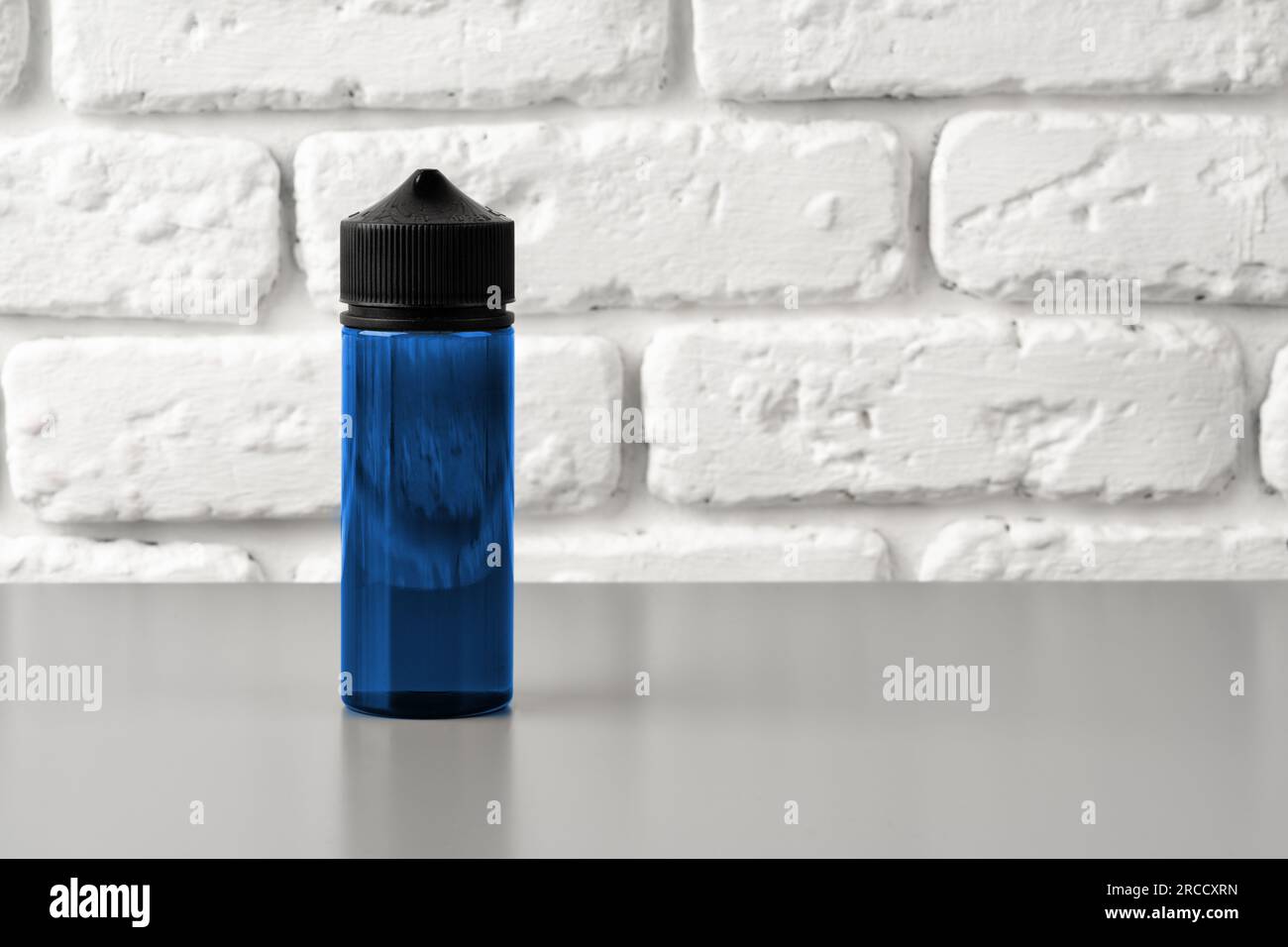 Refill liquid for electronic cigarettes against brick wall background ...