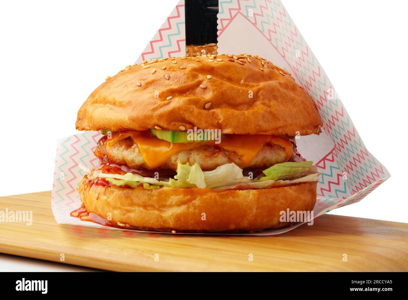 Delicious burger on wooden board isolated on white background Stock ...