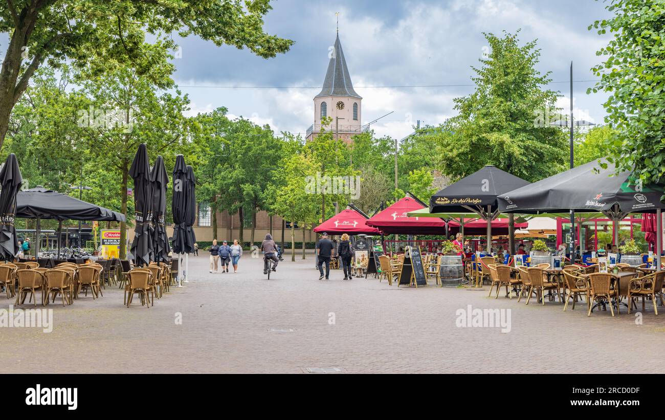 Emmen, The Netherlands - July 2, 2023: Street view of city centre of Emmen with church tower ...