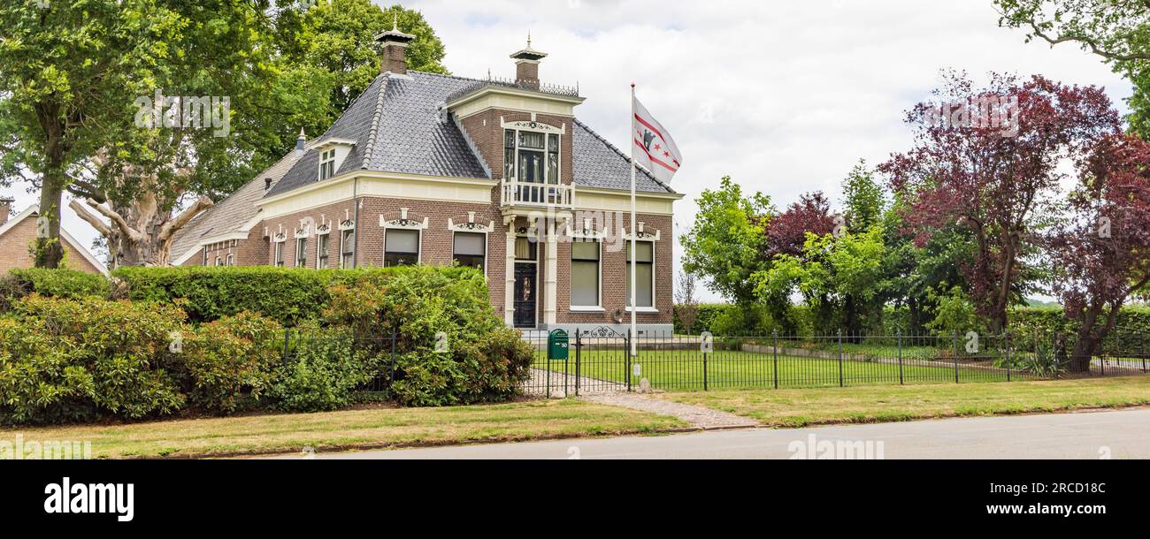 Traditional saxon farm house with Drenthe flag in pictoresque rural ...