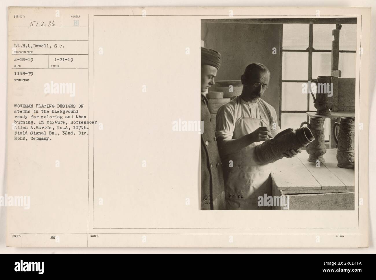 "The image captures a workman in Hohr, Germany, placing designs on ...