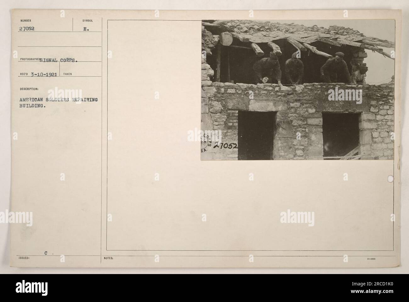 American soldiers working together to repair a building during World ...