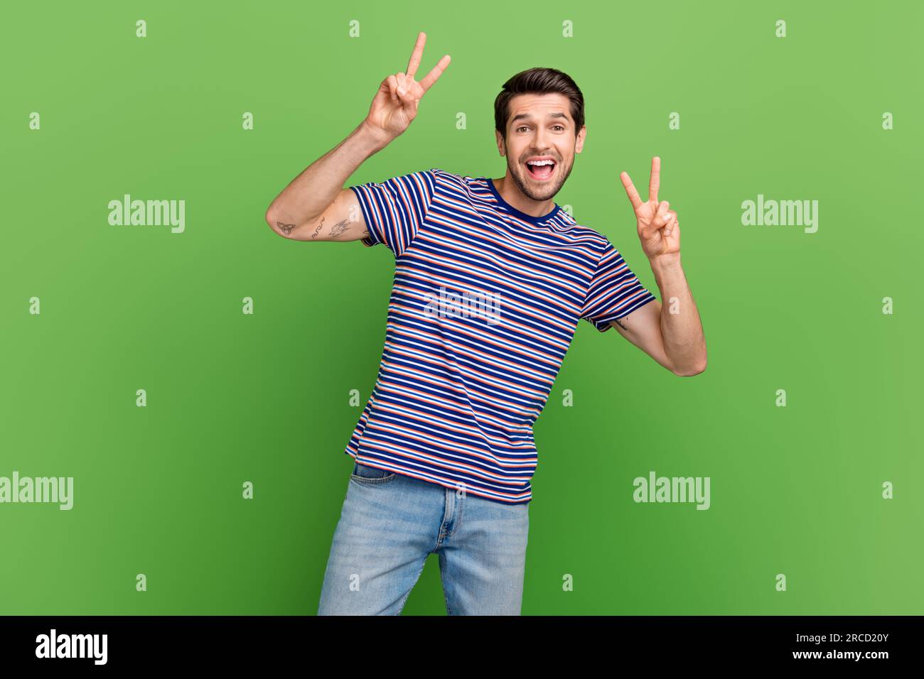 Portrait of optimistic positive pleasant guy with bristle wear striped ...