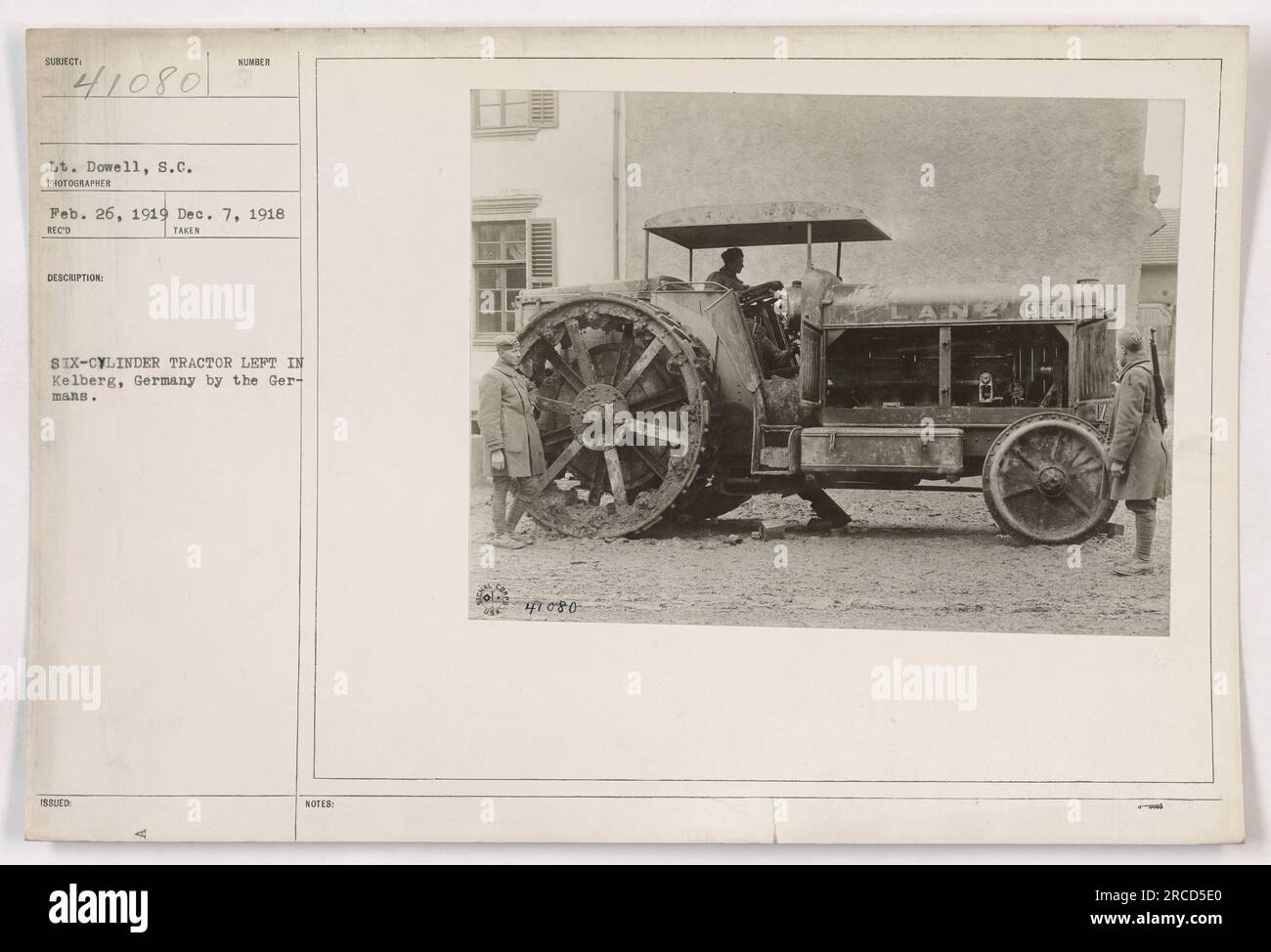 American soldiers inspecting a six-cylinder tractor leftover by the ...