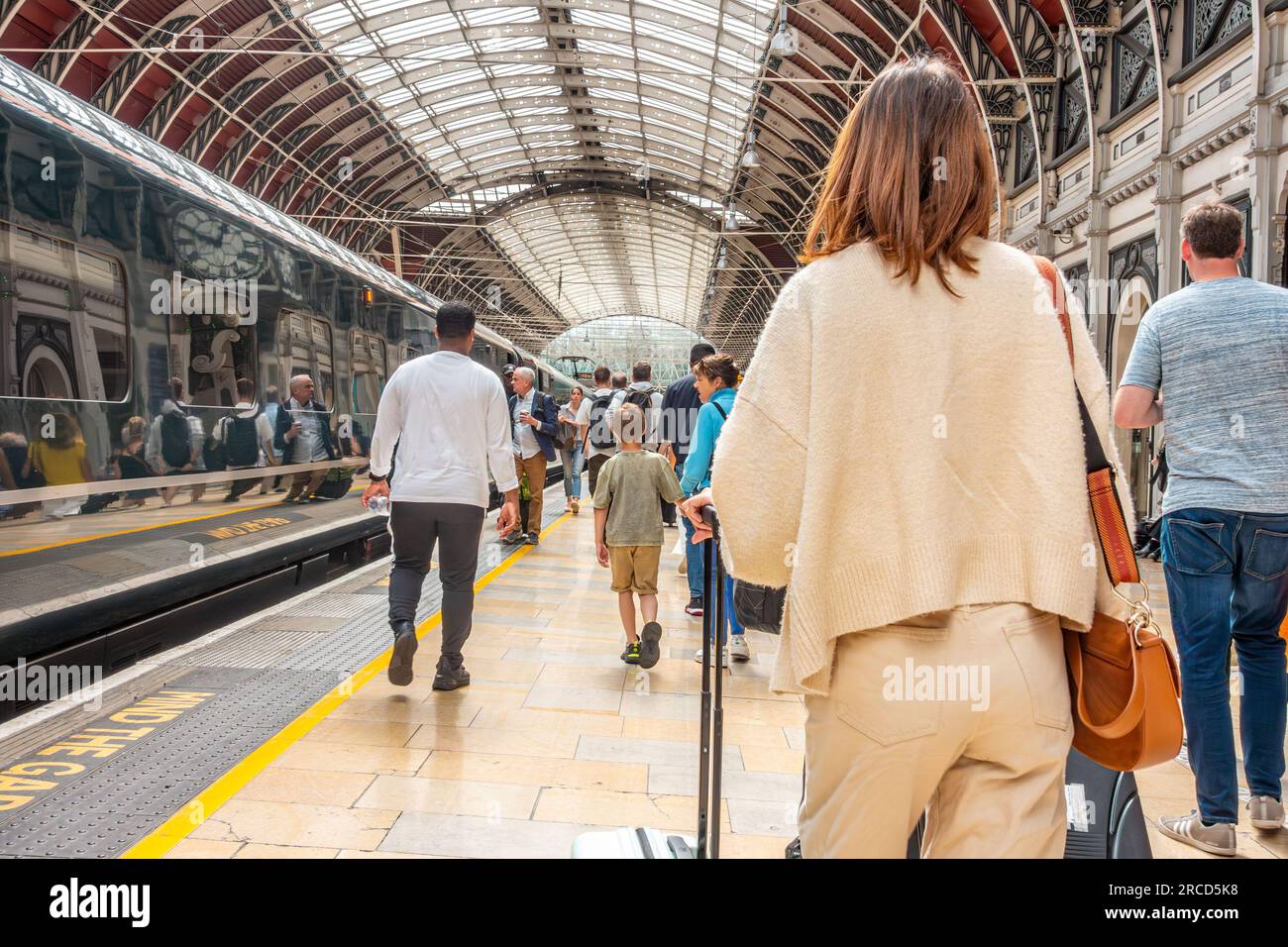 People walking along the platform having disembarked form a train at ...
