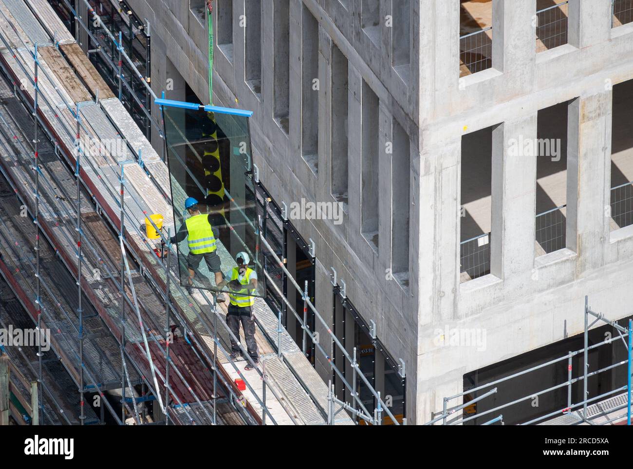 Glazier installing windows on a commercial building Stock Photo - Alamy