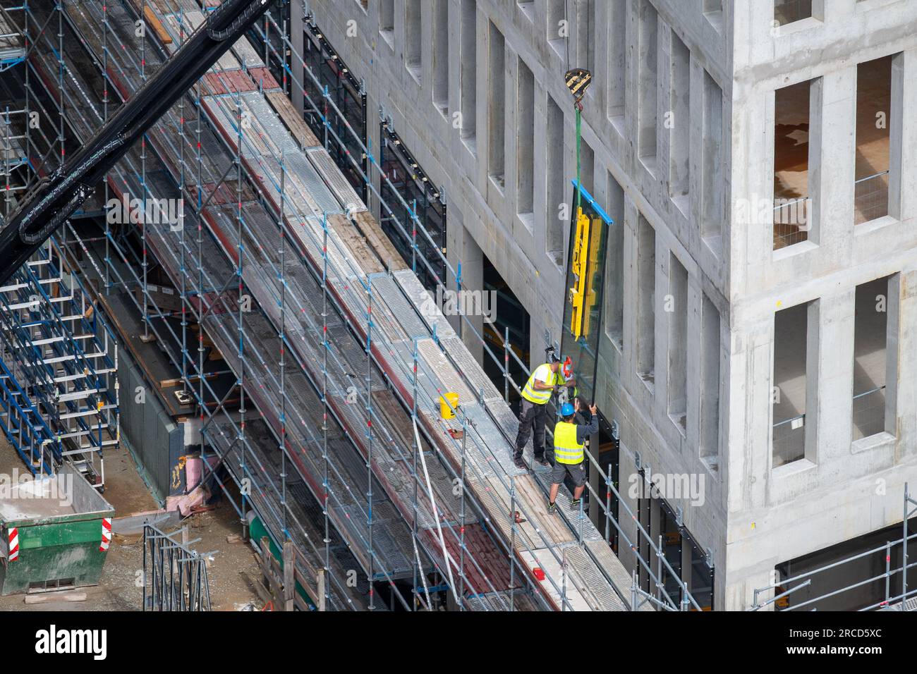 Glazier installing windows on a commercial building Stock Photo - Alamy