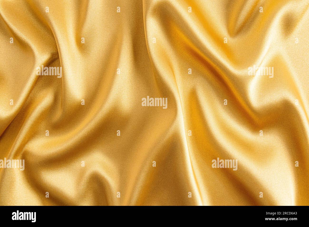 Elegant satin fabric with a golden color. The luxurious texture of the ...
