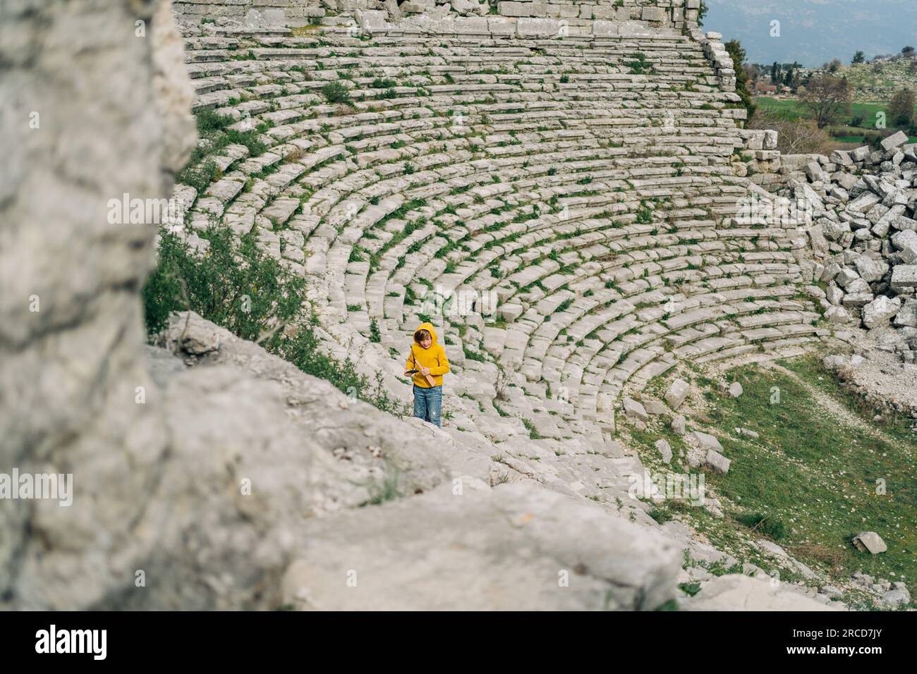 School boy kid in yellow hoodie and blue jeans exploring remains of ...