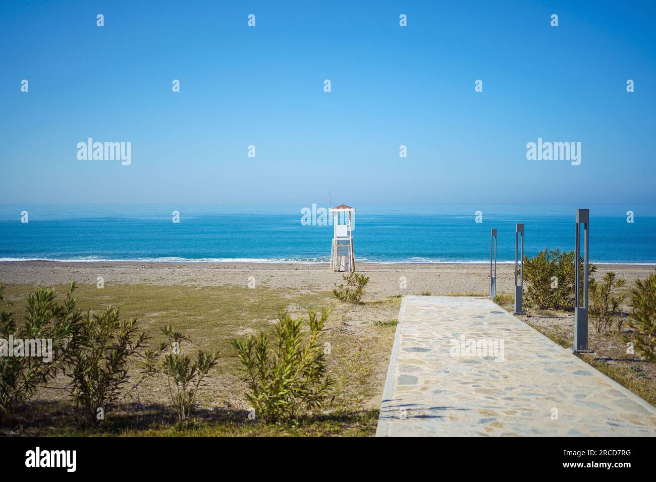Scenic view of concrete pathway to the empty bay watch tower on a ...