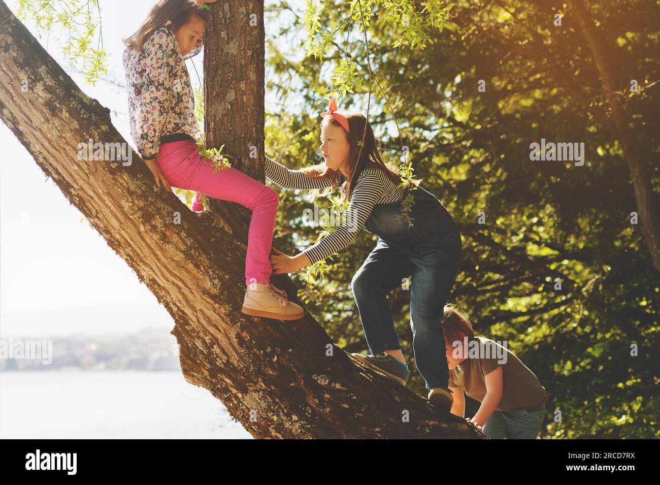 Group of young happy kids playing outside on a nice summer day ...