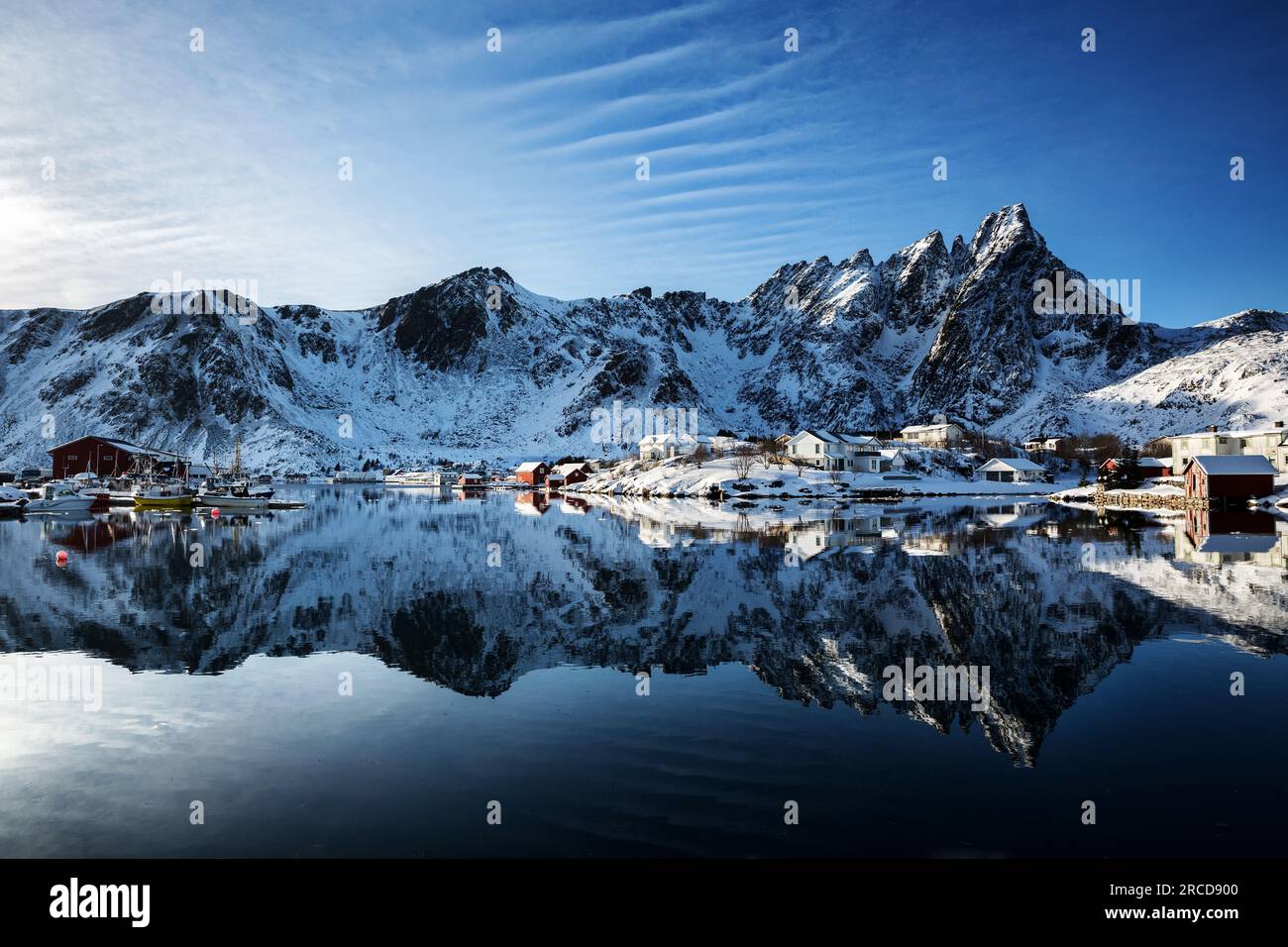 Mountains and village in Norway with reflection in the sea, winter ...