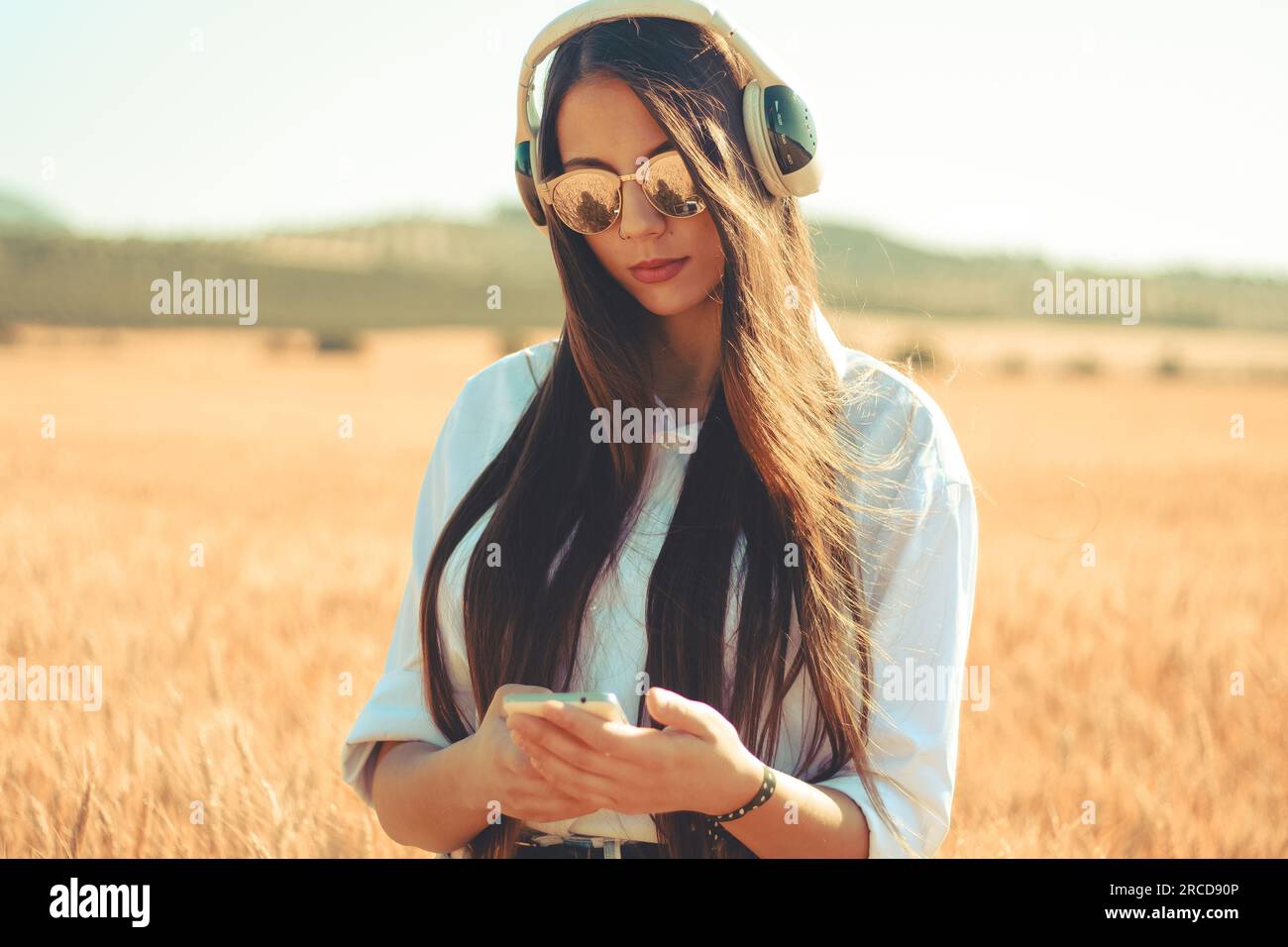 A millennial using different devises outdoor Stock Photo - Alamy