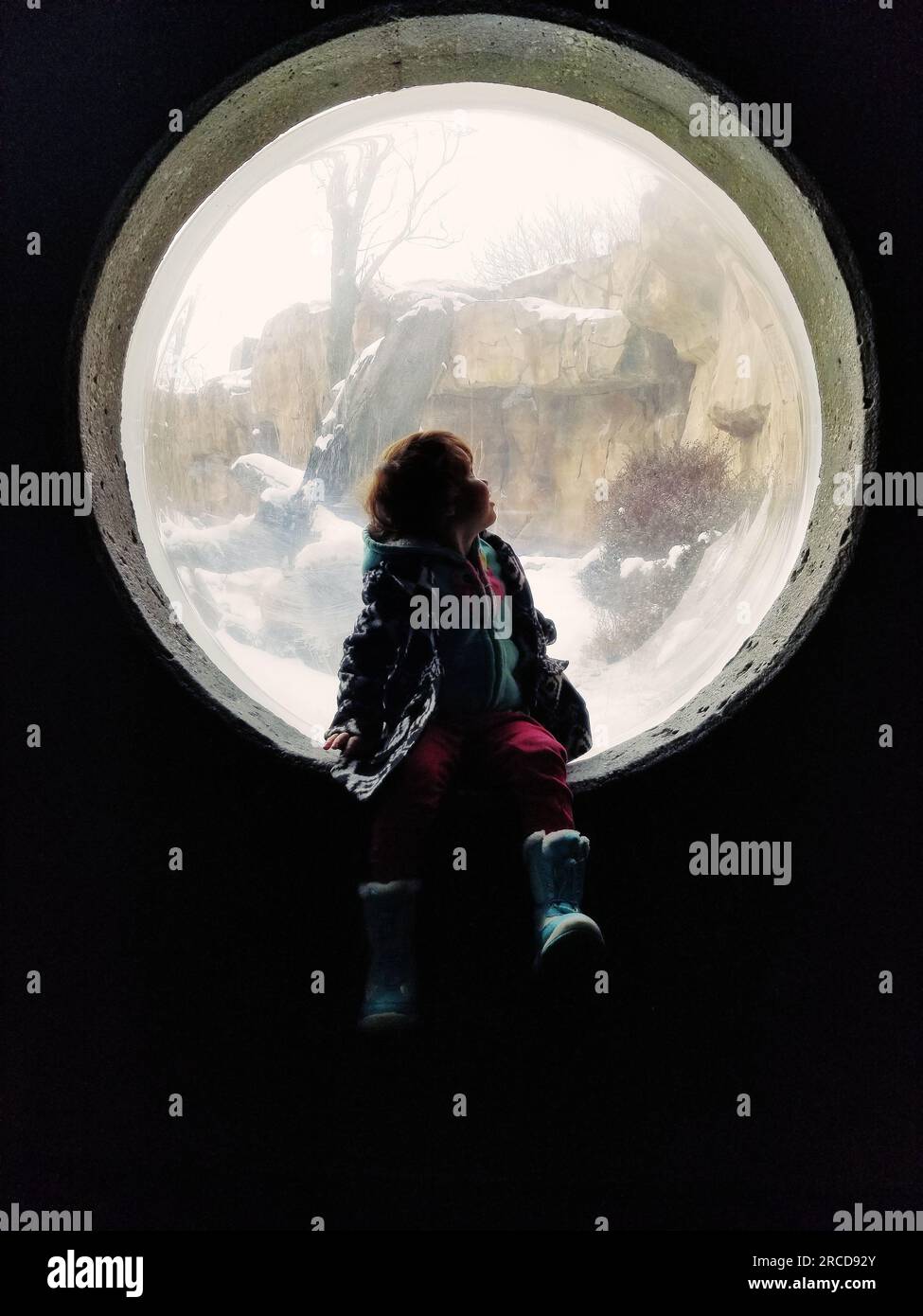 Girl looking out big window Stock Photo - Alamy