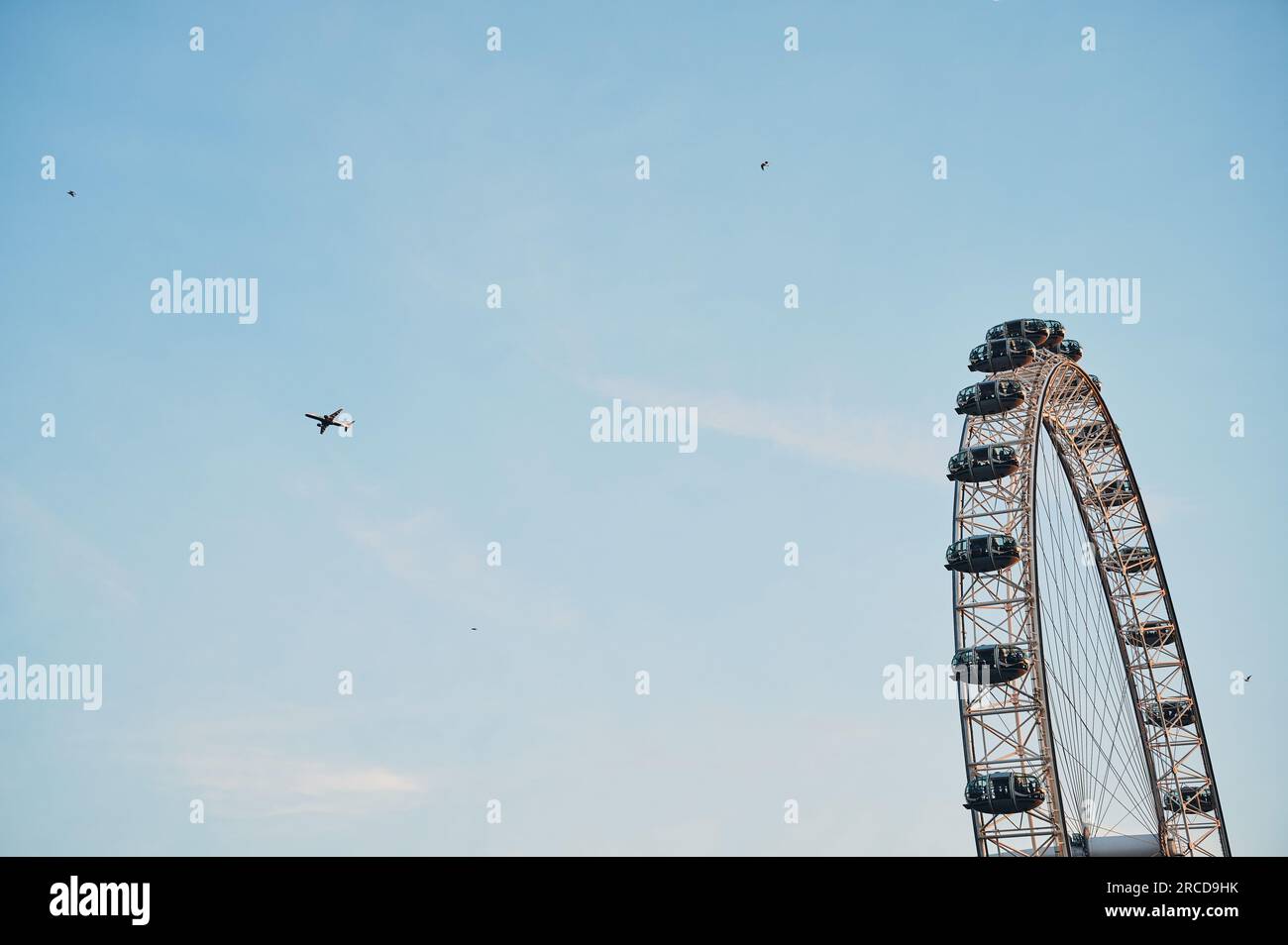 Plane flying near Ferris wheel Stock Photo - Alamy