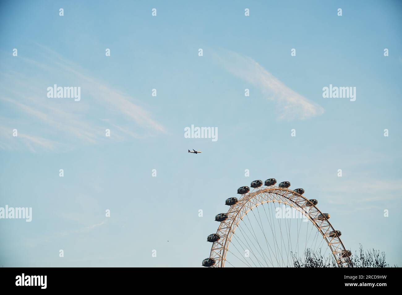 Aircraft flying over observation wheel Stock Photo - Alamy