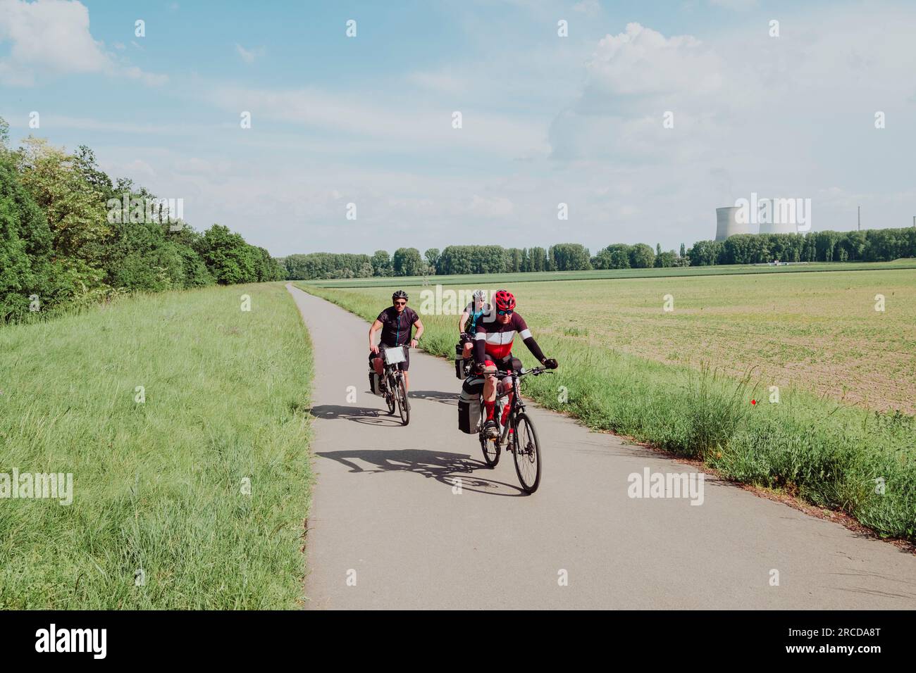A group of cyclists riding his bikes in the Rin river route in Germany ...