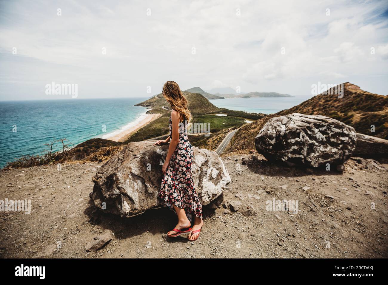 Tween girl looks at the view of St Kitts and Nevis mountains Stock ...