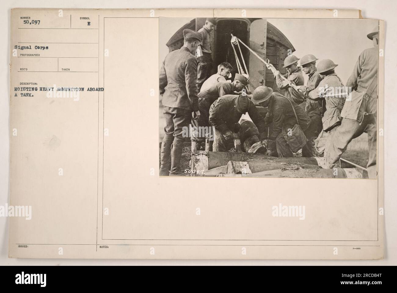 Soldiers loading ammunition onto a tank during World War I. The tank in ...