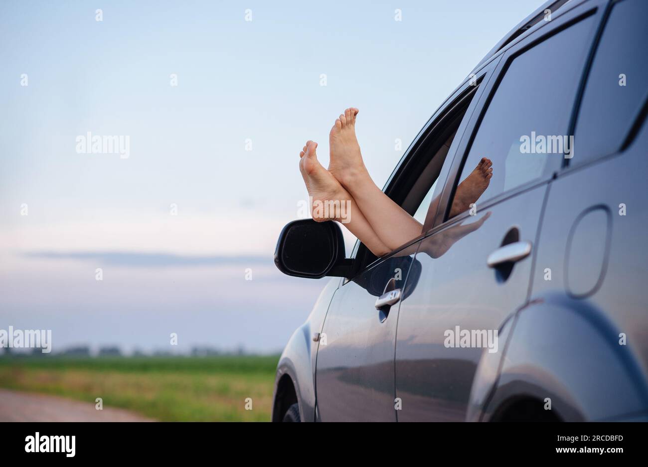 The legs are visible from the car window Stock Photo - Alamy