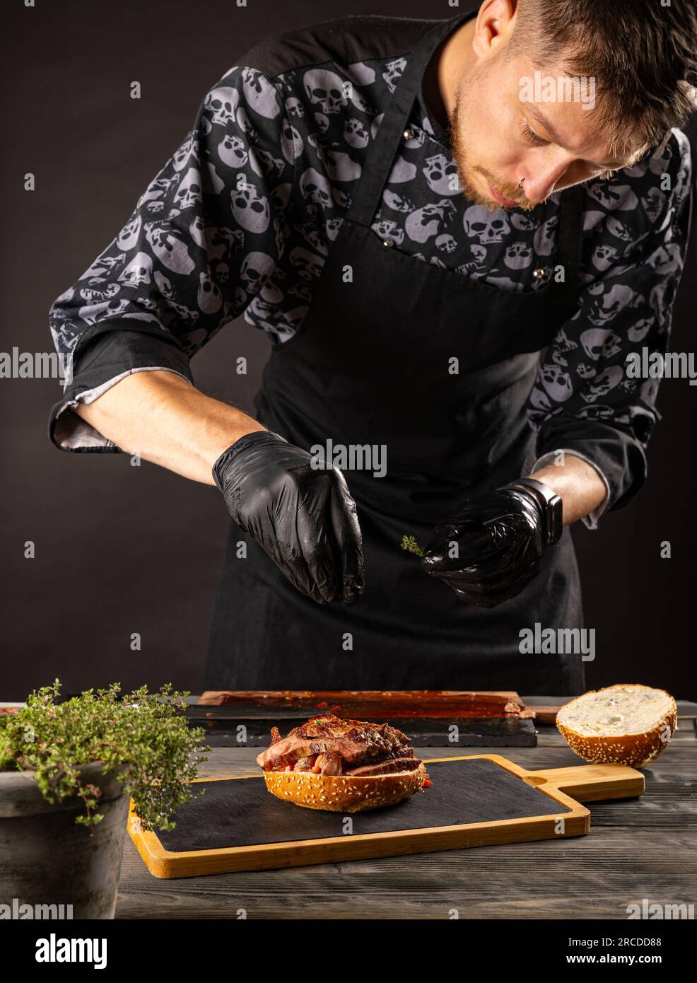 Cooking steak burger concept. Cook preparing steak burger adding meat ...