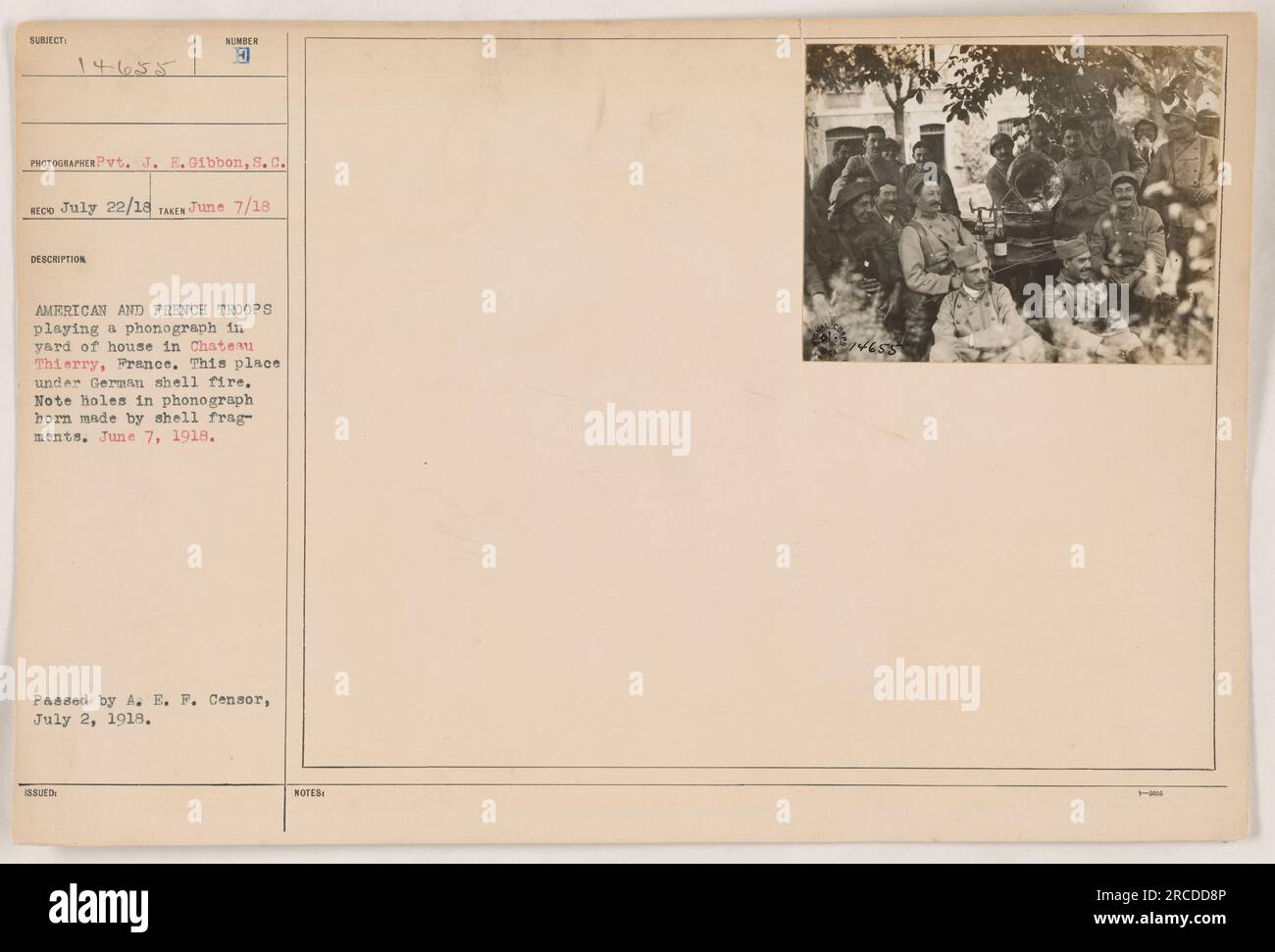 American and French troops playing a phonograph in the yard of a house ...