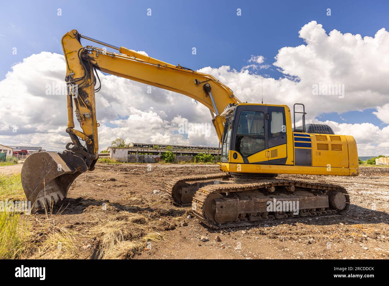 Crawler excavator front view digging on demolition site Stock Photo - Alamy