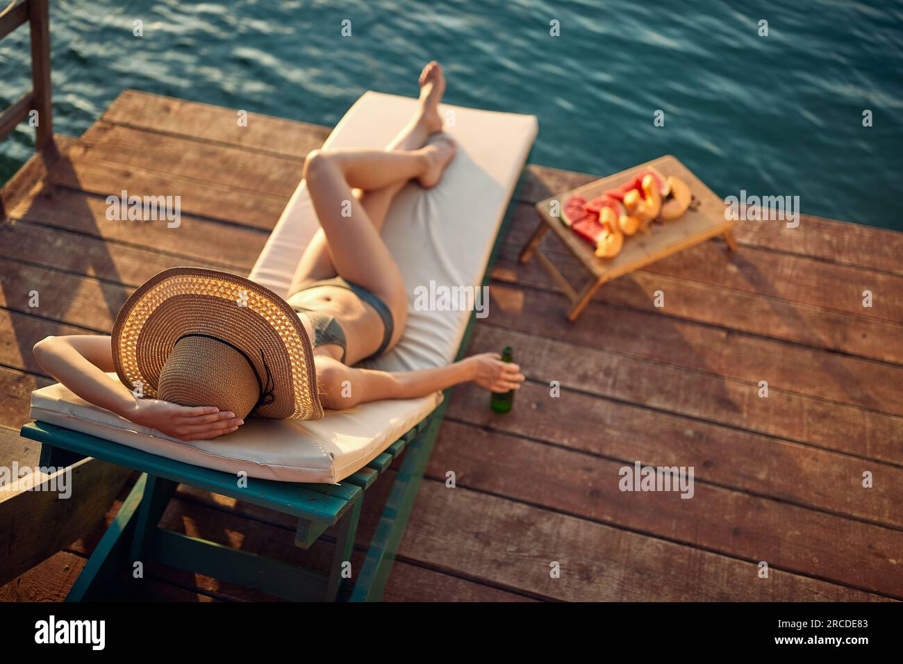 A Birds Eye View Of A Young Girl In Bikini Lying On A Sunbed And