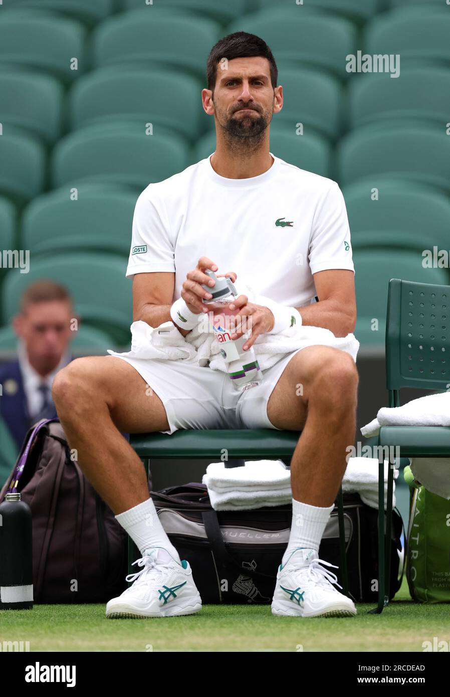 Novak Djokovic takes a seat during a practice session on court one, on ...