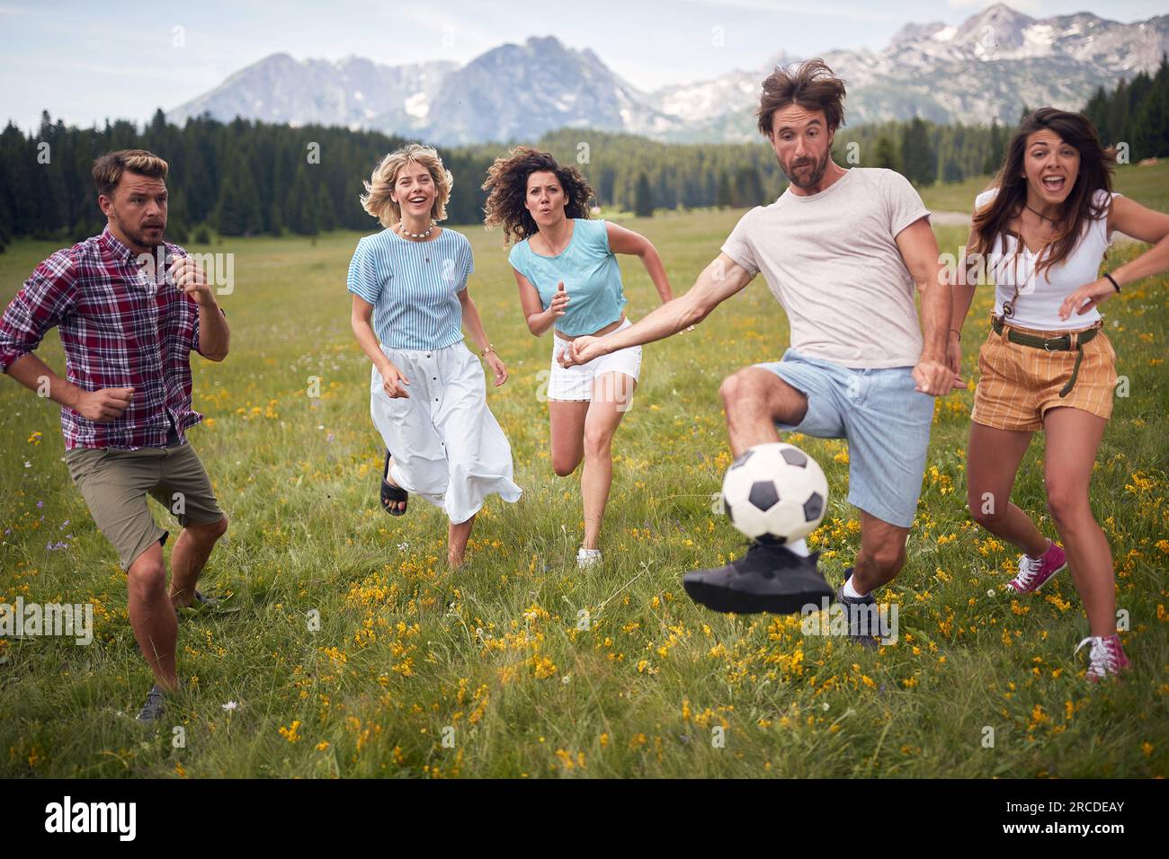 Group of people playing with ball. sport outdoors of a group of friends ...